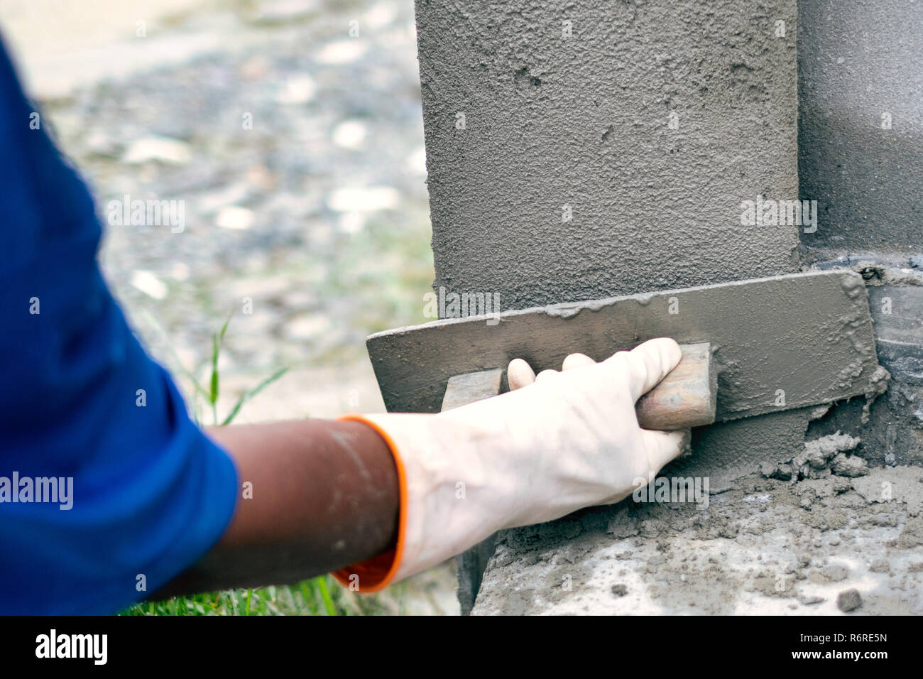 closeup of hand plastering cement on the wall in the construction work ...
