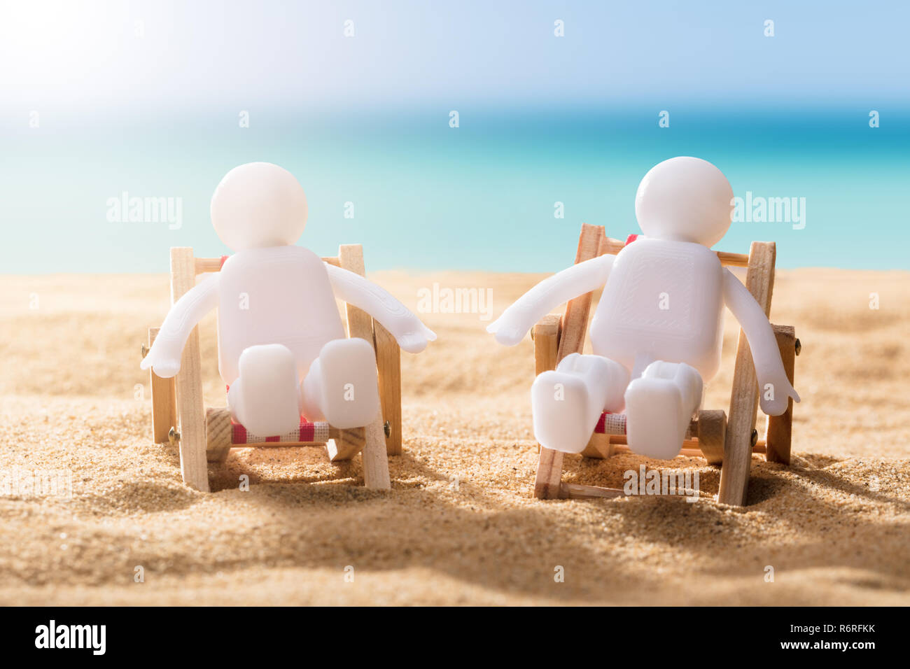Two Human Figures Relaxing On Deck Chairs Stock Photo - Alamy