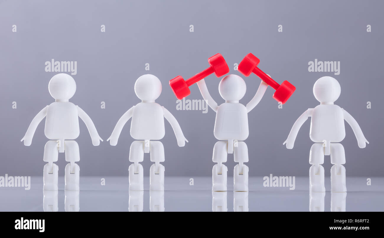 Human Figures Exercising With Red Dumbbells Stock Photo - Alamy