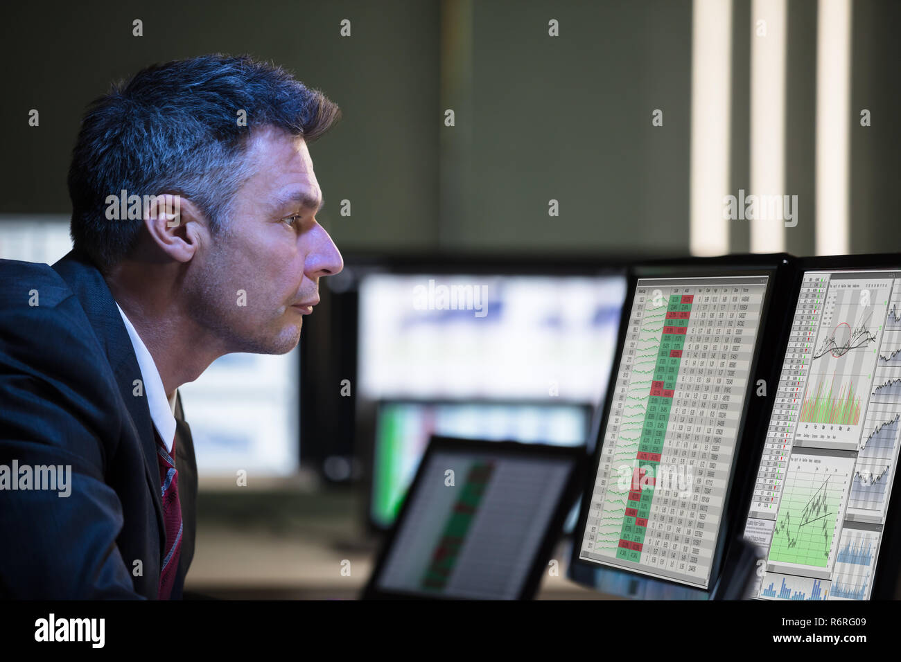 Stock Market Broker Analyzing Graph On Multiple Computer Screen Stock ...