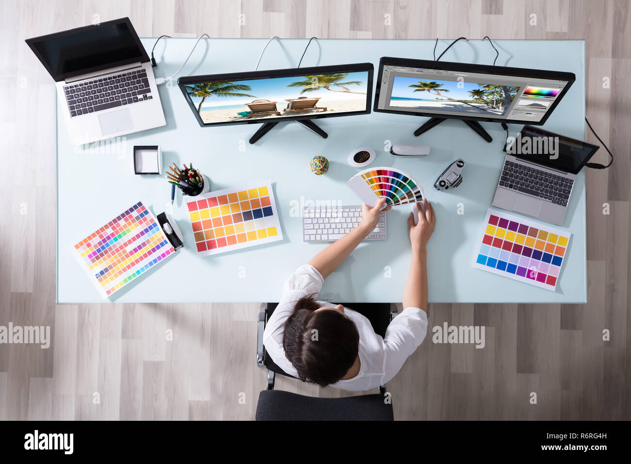 Designer Using Color Swatch While Working On Multiple Computer Stock ...