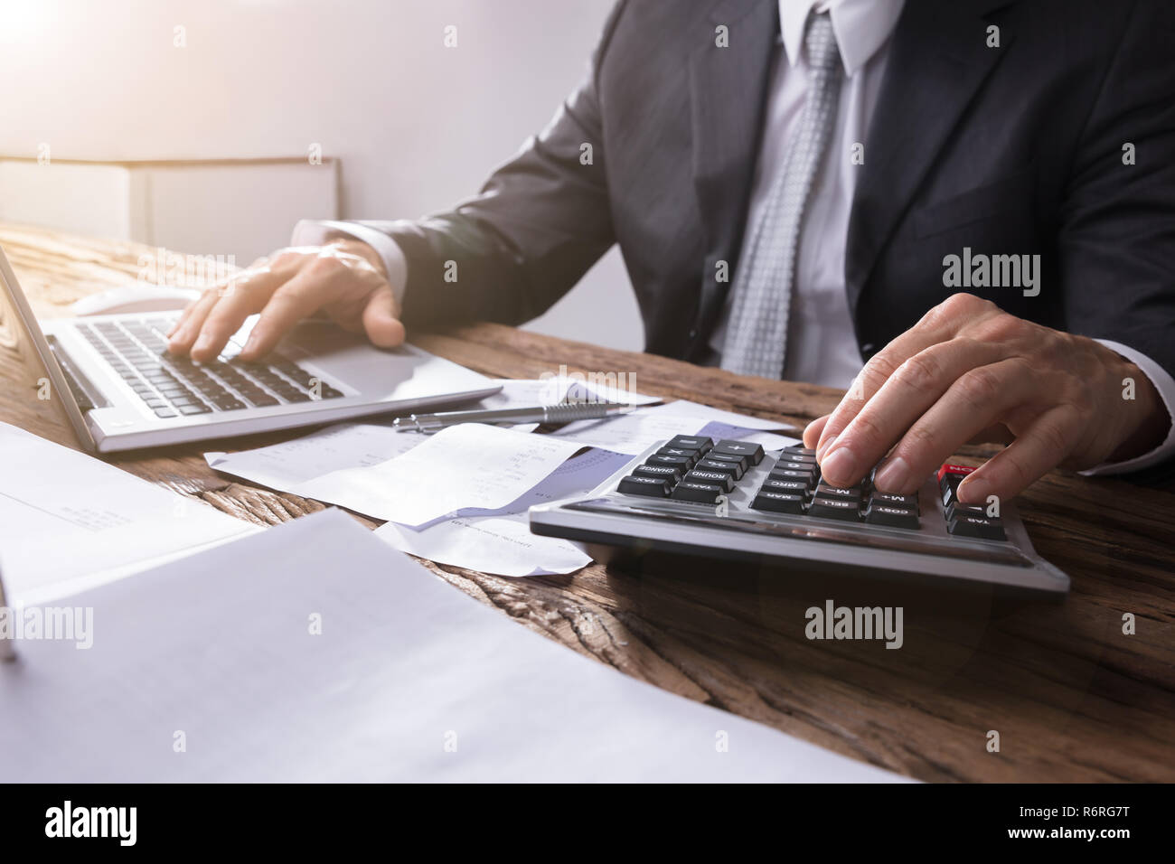 Businessperson's Hand Using Calculator Stock Photo - Alamy