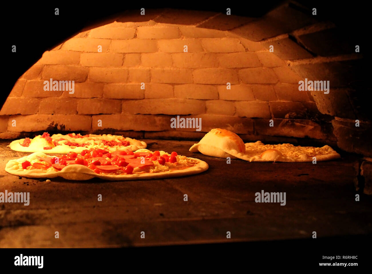 Pizza baking close up in the oven. Image of a brick pizza oven Stock ...