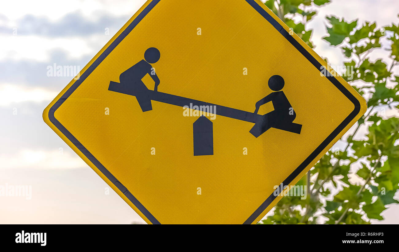 Playground sign with tree and sky in background Stock Photo - Alamy