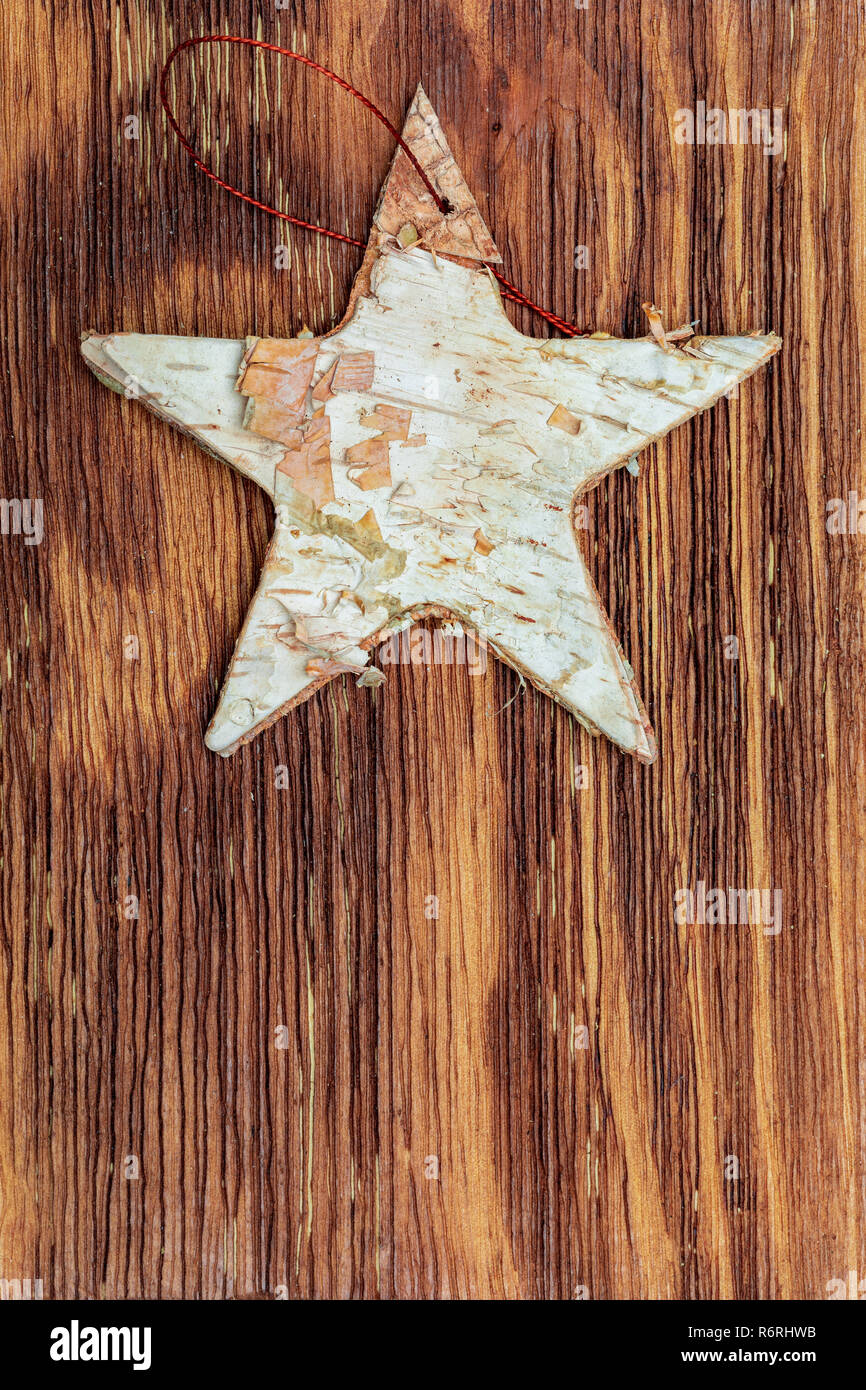 Beautiful star of birch bark on wooden craftsman background. Ready for ...
