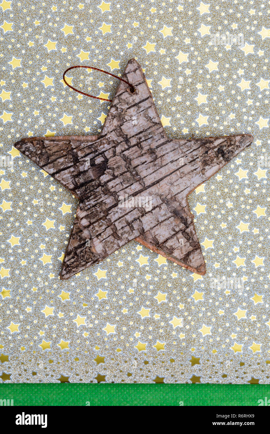 Beautiful star of birch bark on golden and green stars background ...