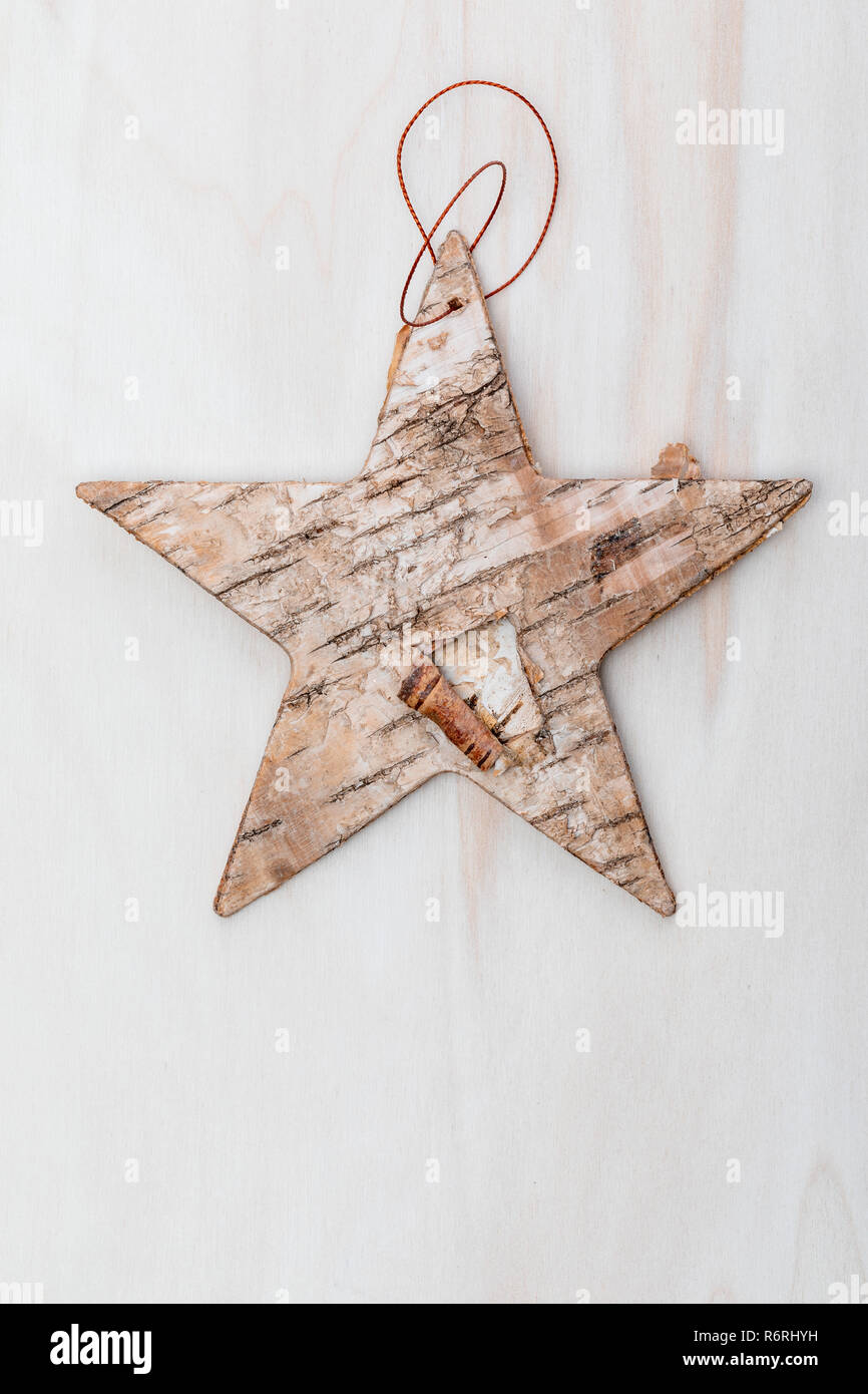 Beautiful star of birch bark on wooden craftsman background (light ...