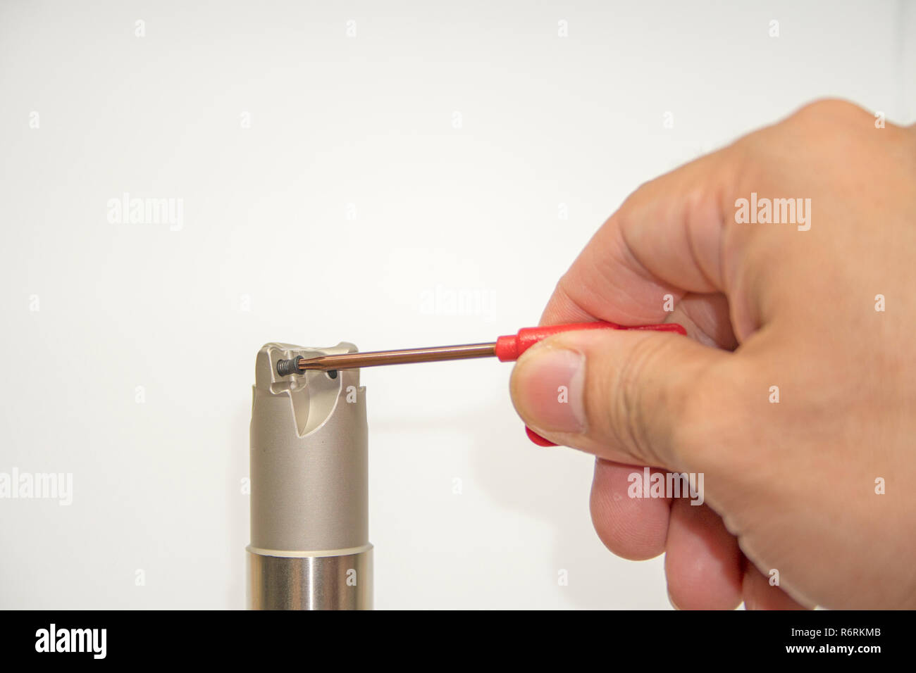 Screwdriver of cutting machine tool by hand Stock Photo - Alamy