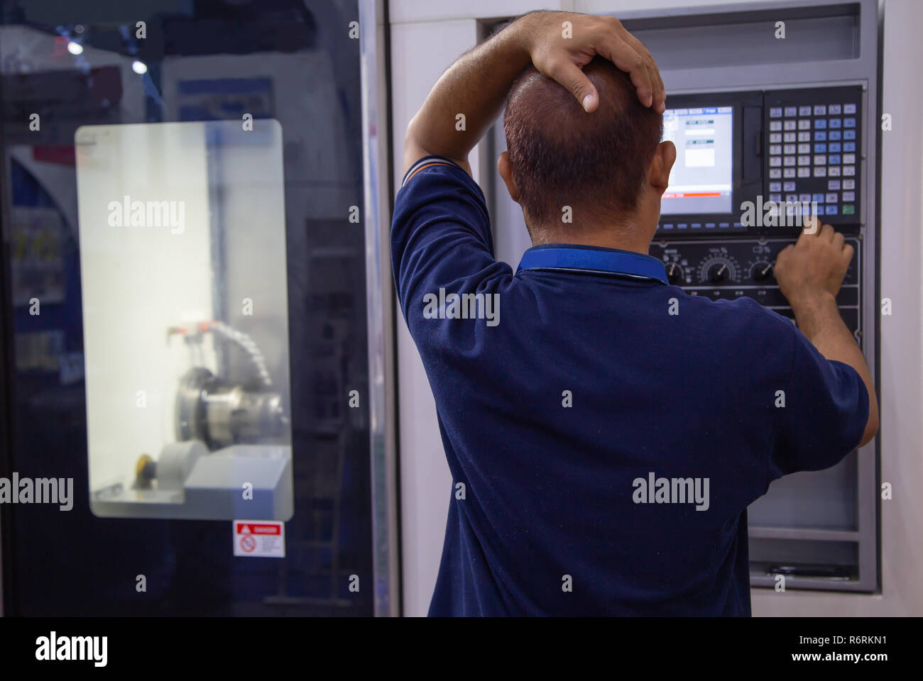 Industrial worker input data programing for CNC lathing machine Stock Photo - Alamy