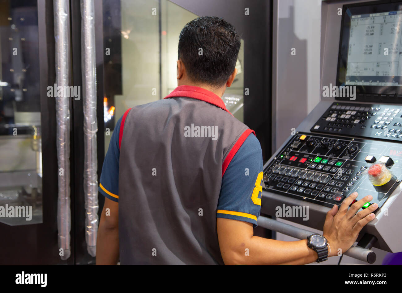 Industrial worker input data programing for CNC milling machine Stock Photo - Alamy