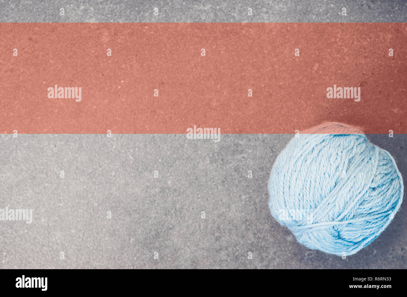 light blue ball of yarn on a rough stone surface - colored rectangular ...