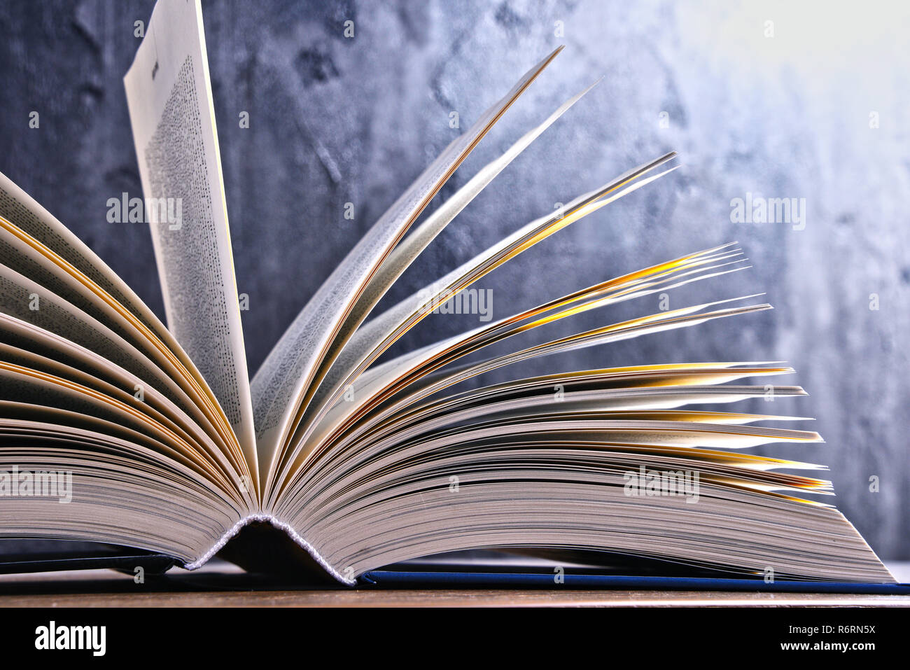 Composition with open book Stock Photo - Alamy