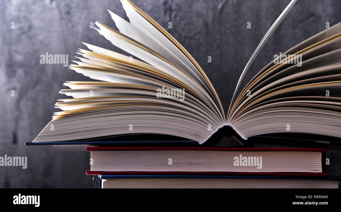 Composition with open book Stock Photo - Alamy