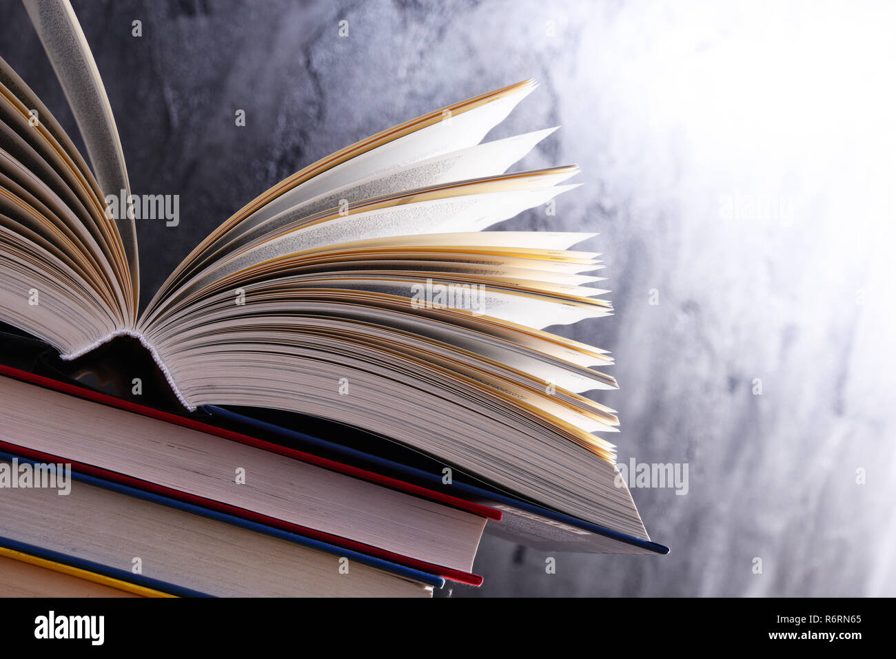Composition with open book Stock Photo - Alamy