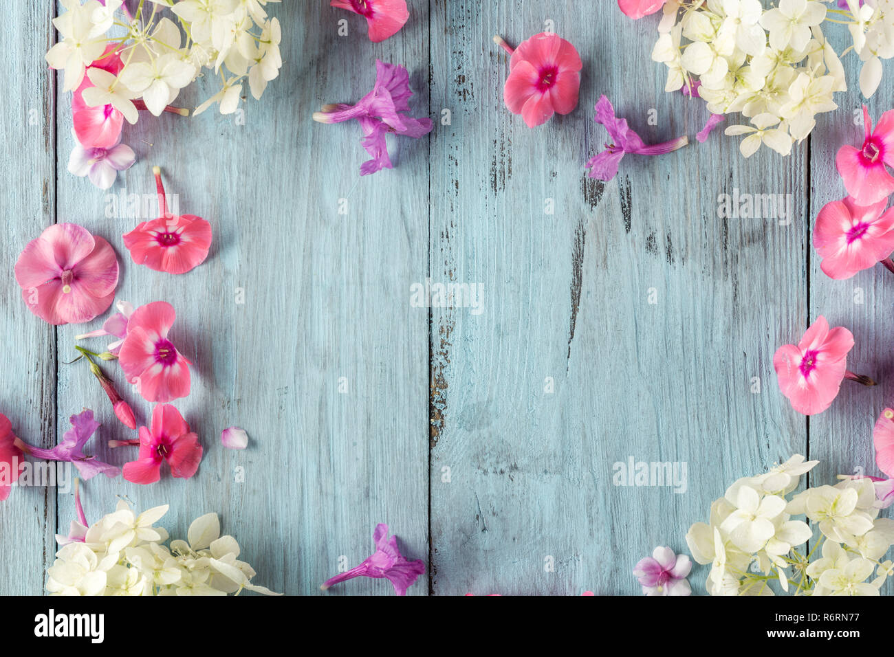 frame of flowers, background blue boards Stock Photo - Alamy