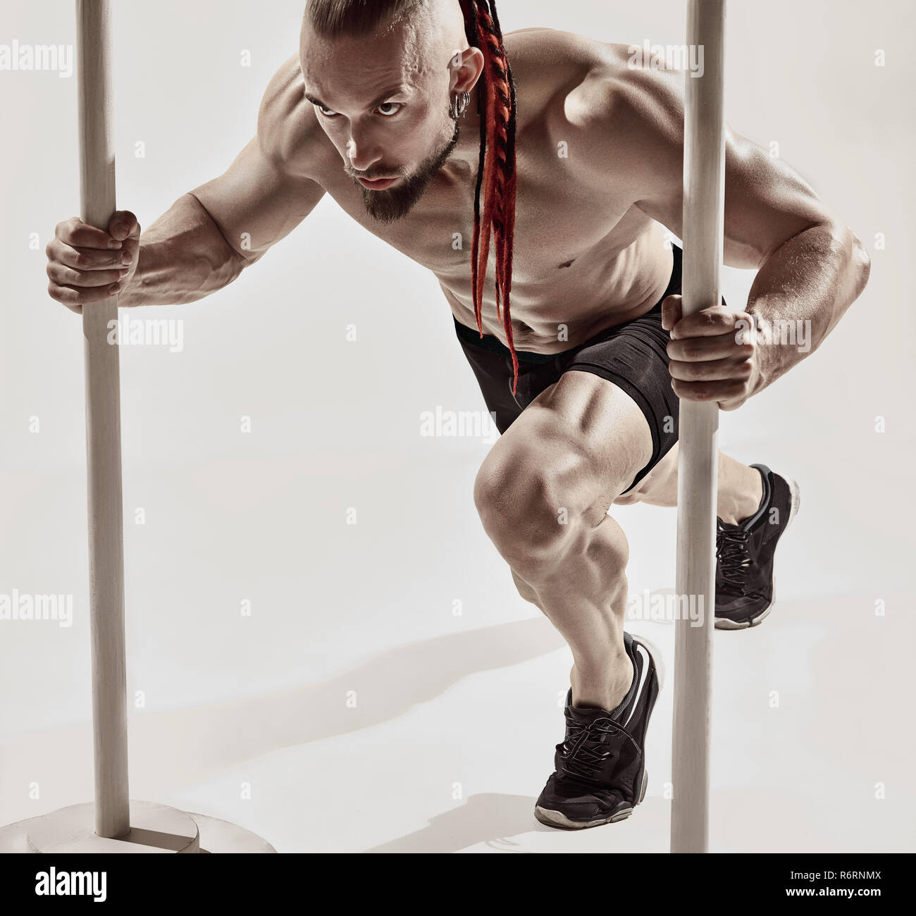 the handsome guy is wrung out in the gym Stock Photo - Alamy