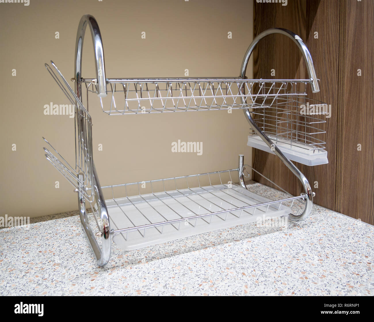 Dish dryer stands on the kitchen table Stock Photo - Alamy