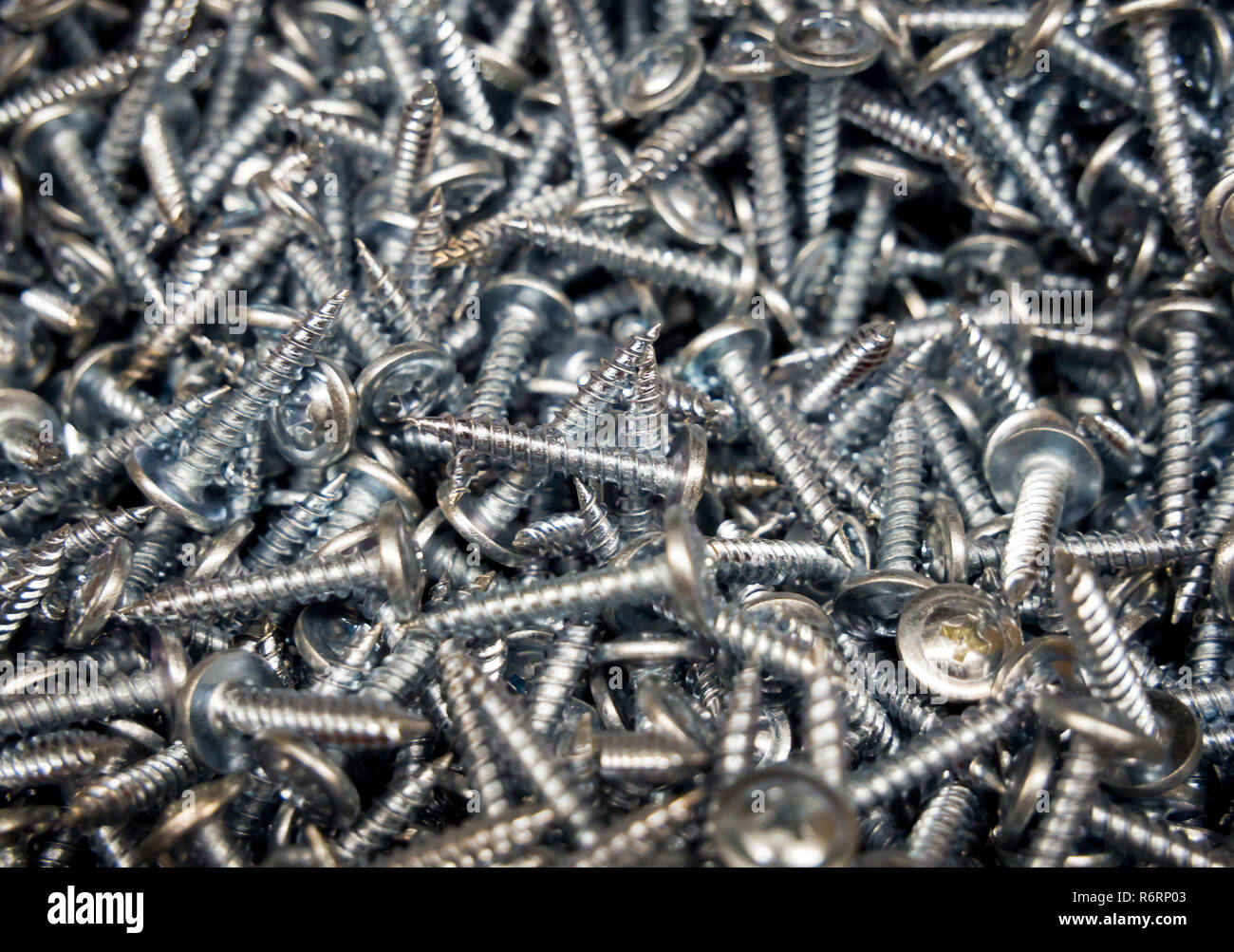 Background image of small screws in bulk Stock Photo - Alamy