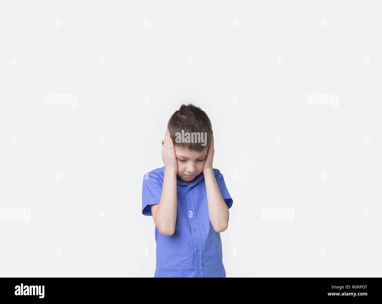 Close-up of a teenage boy with a headache, isolated on a white ...