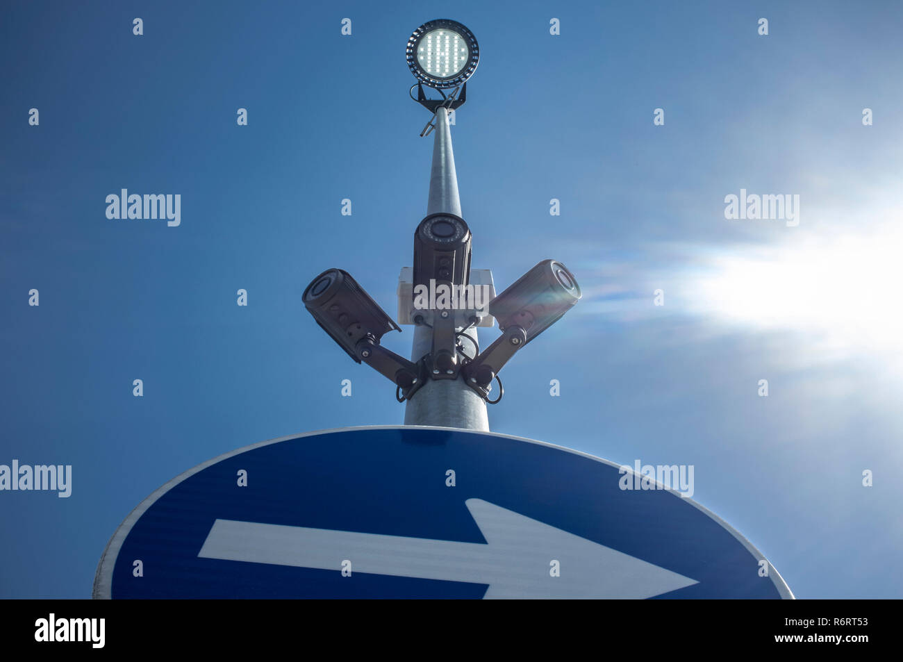 Three surveillance cameras attached on led light pole with direction ...