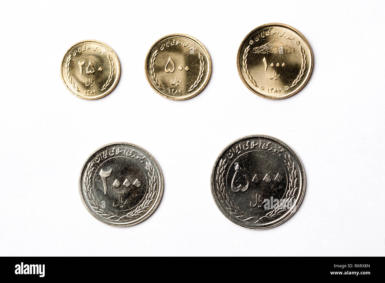 Iranian coins on a white background Stock Photo - Alamy