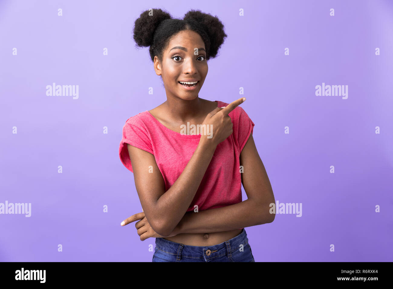 Photo of attractive african american woman pointing finger aside at ...