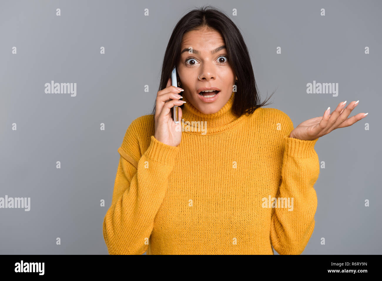 Image of a shocked surprised woman posing isolated over grey wall ...