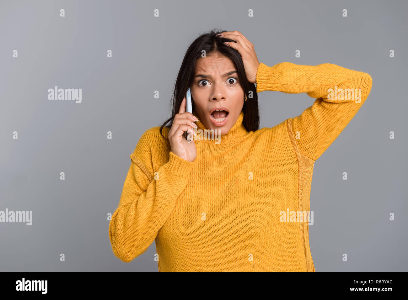 Image of a shocked surprised woman posing isolated over grey wall ...
