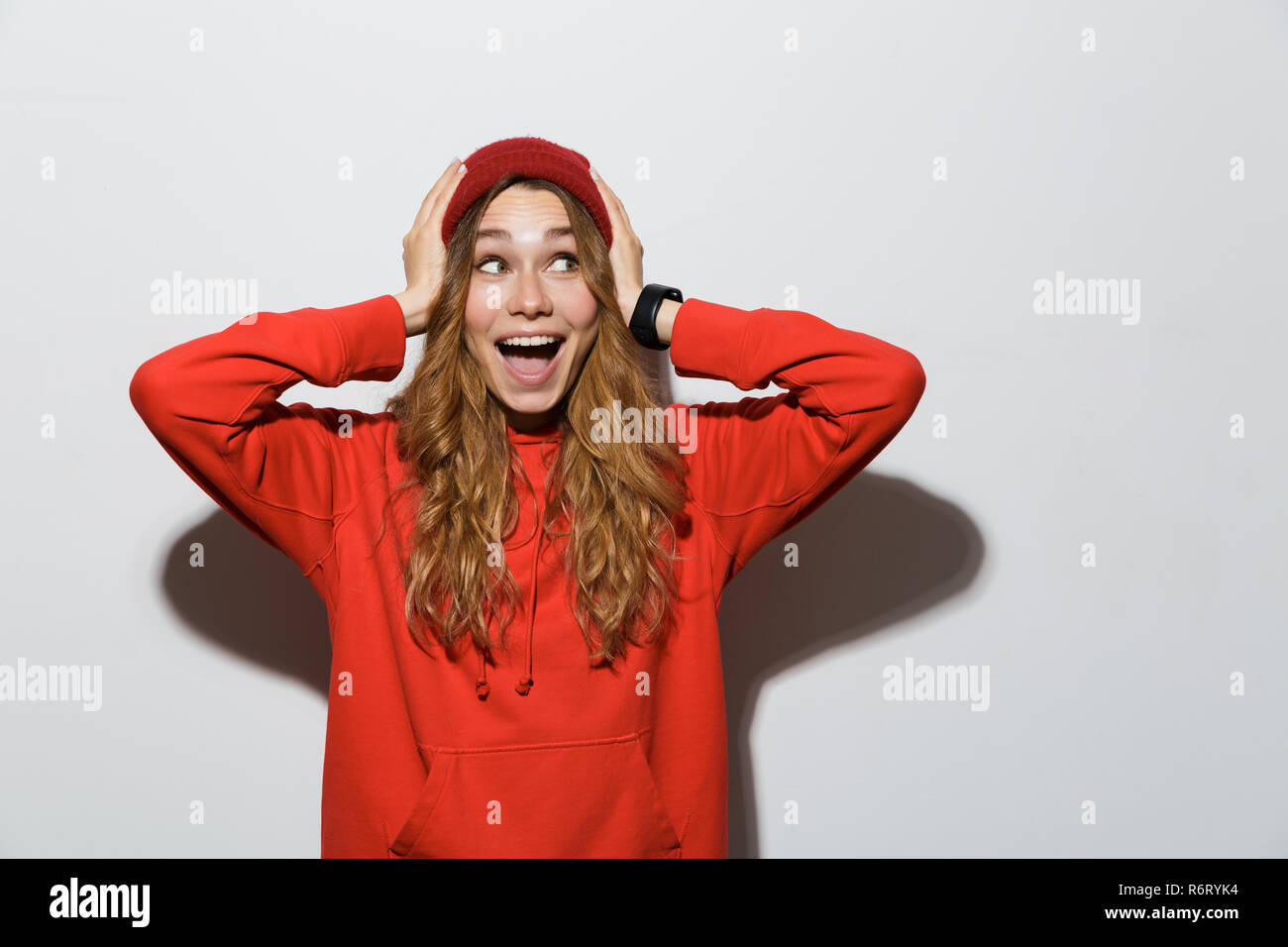 Image of beautiful woman in basic clothing screaming and covering ears ...