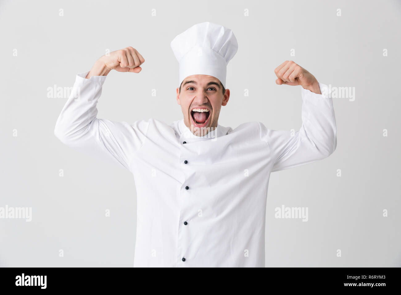 Image of handsome excited young man chef indoors isolated over white ...