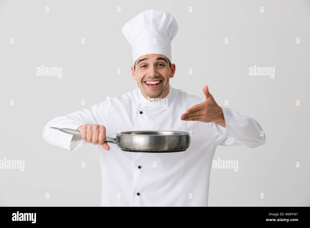 Image of excited emotional young man chef indoors isolated over white ...