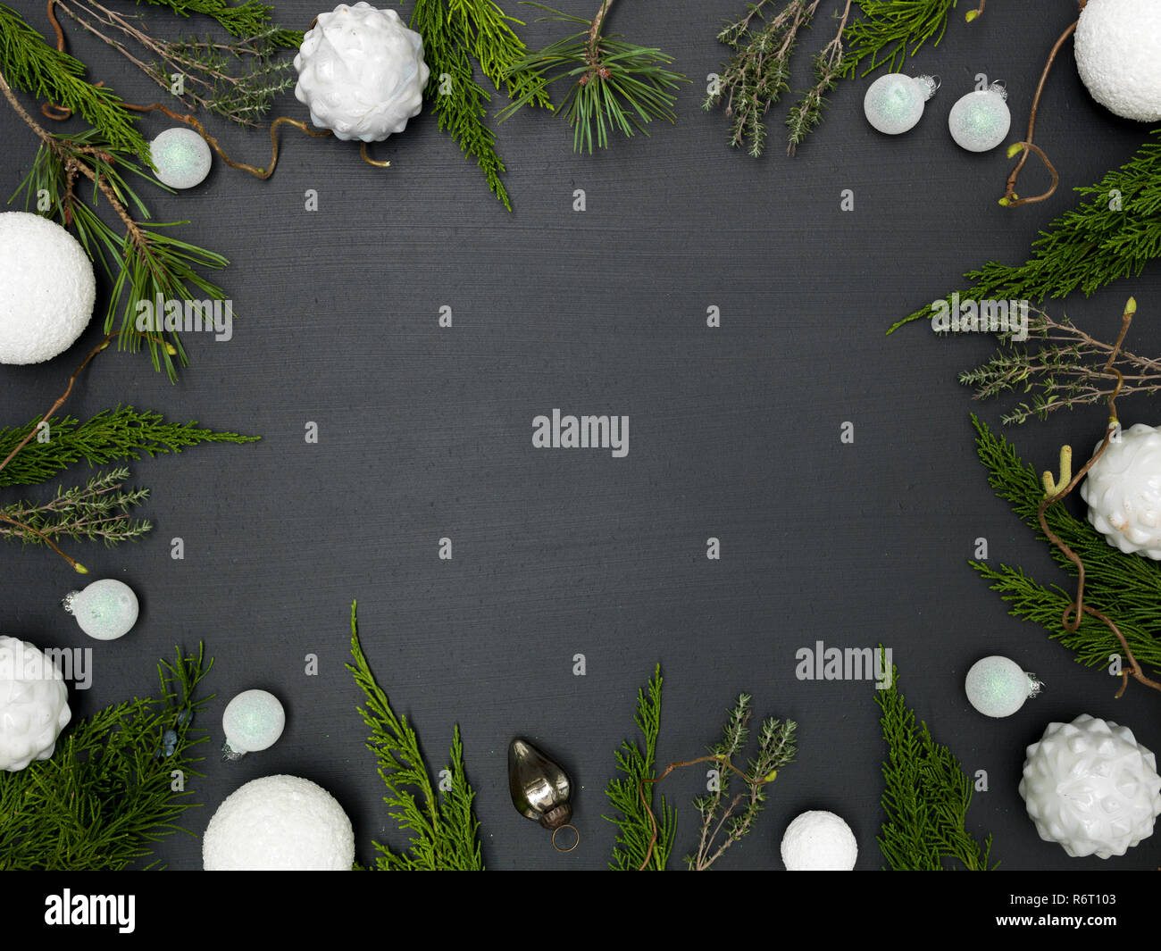 christmas background with frame with white baubles, green branches and ...