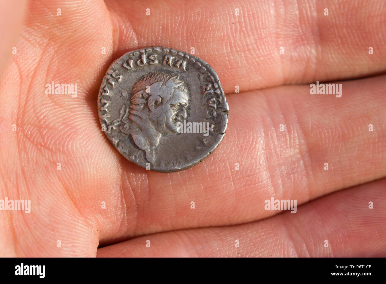Hand holding Roman denarius (Roman silver coin Stock Photo - Alamy