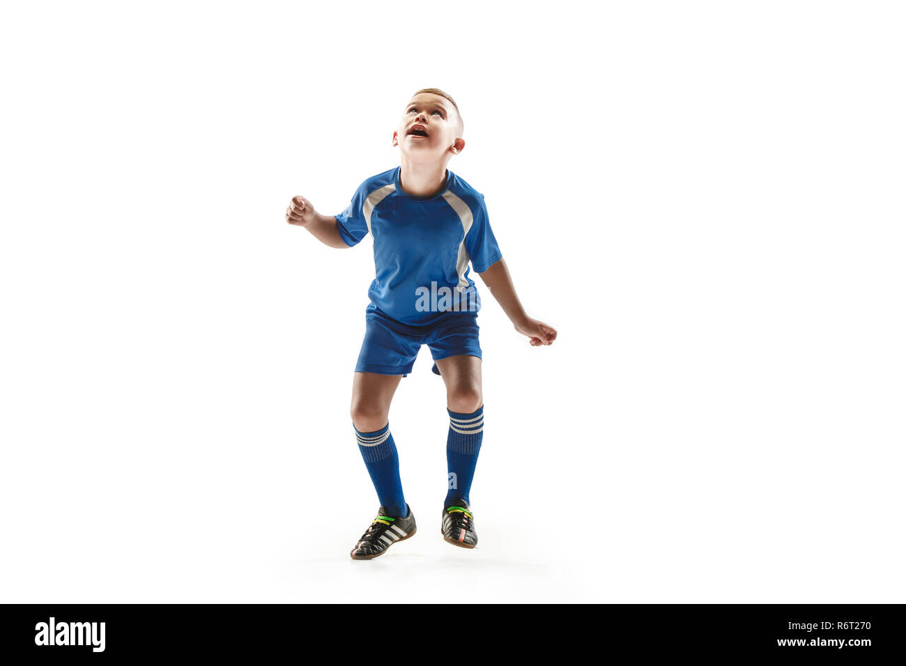 Young boy with soccer ball doing flying kick, isolated on white ...