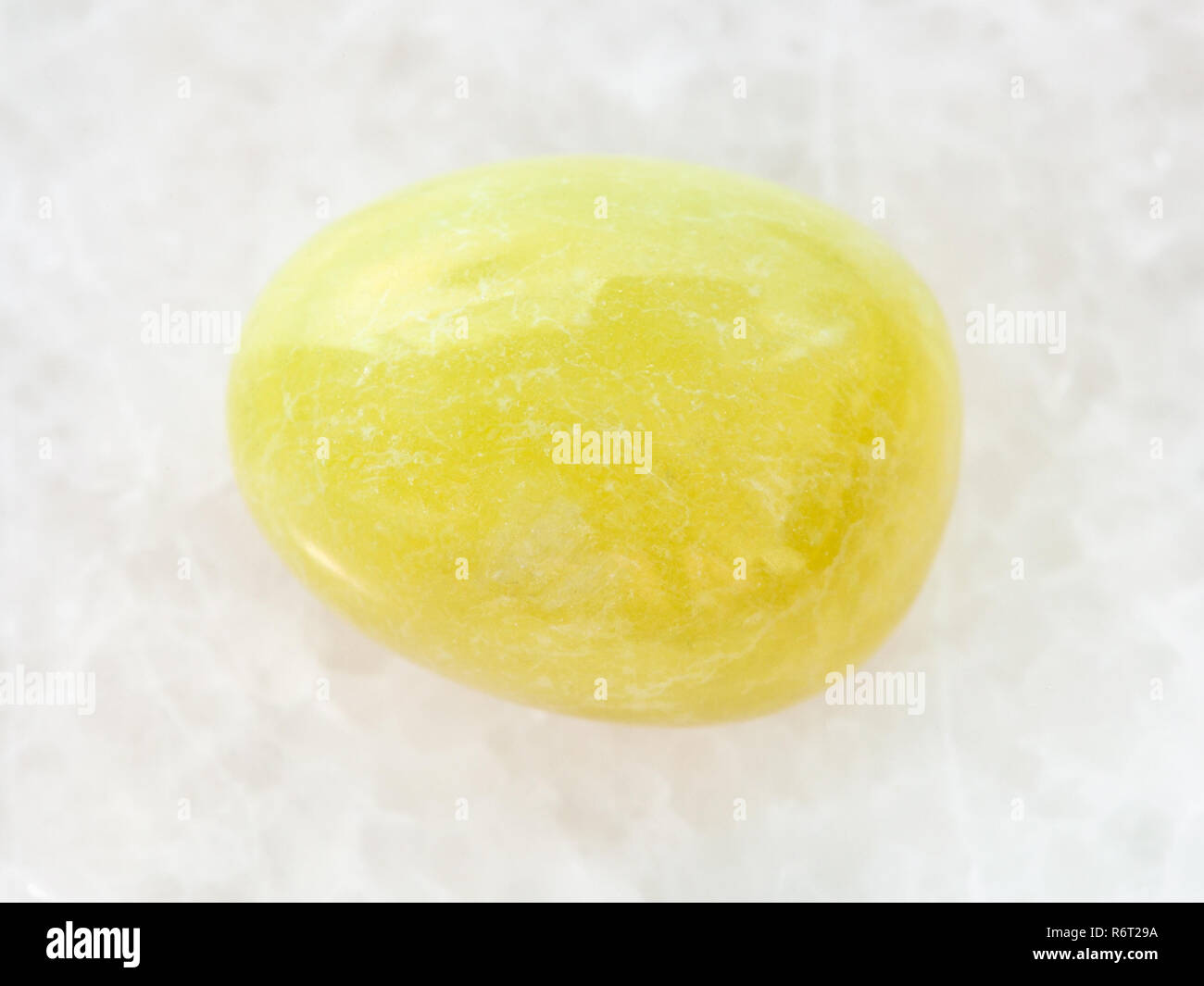 tumbled yellow calcite gemstone on white marble Stock Photo - Alamy