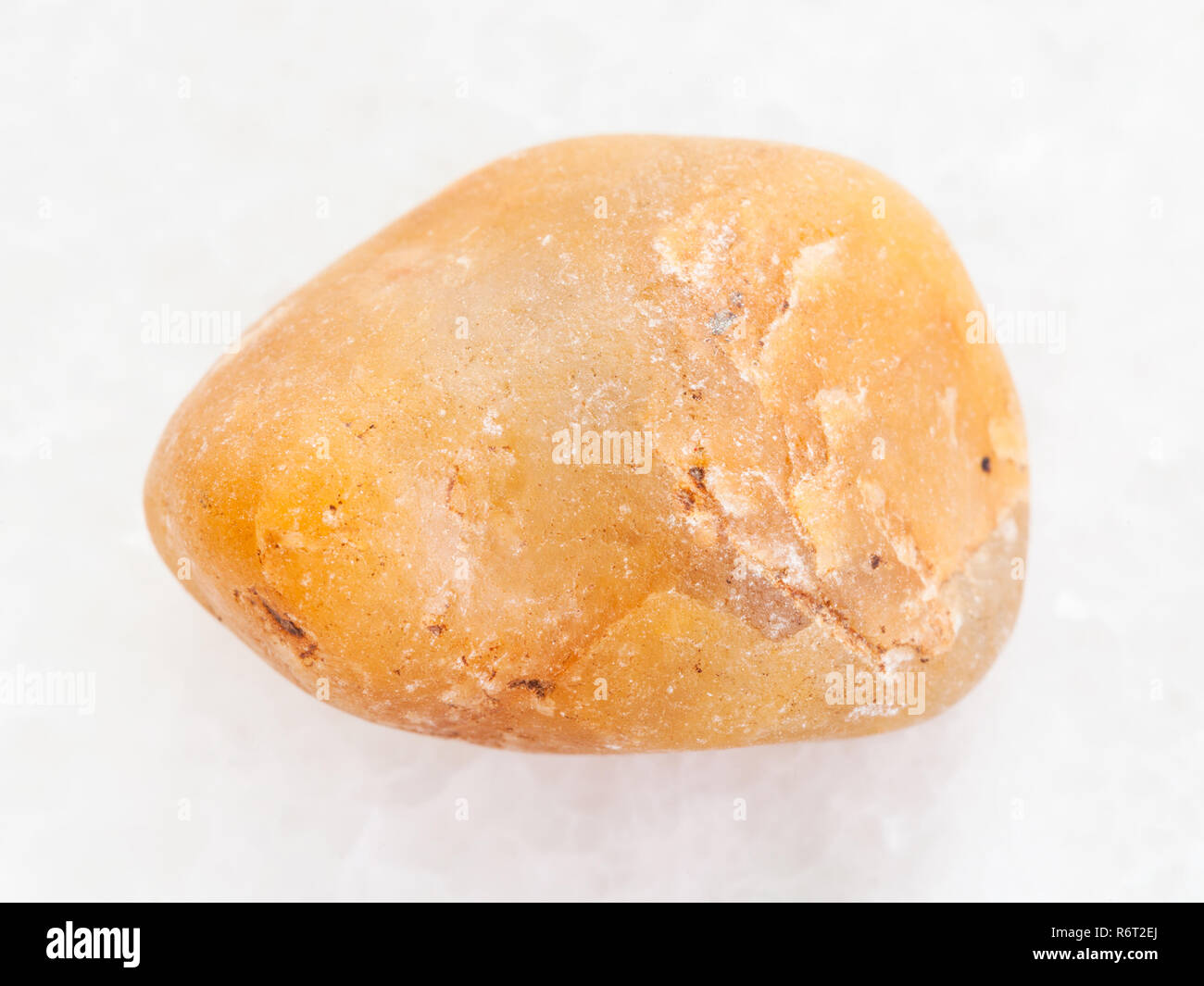 tumbled yellow chalcedony stone on white marble Stock Photo - Alamy