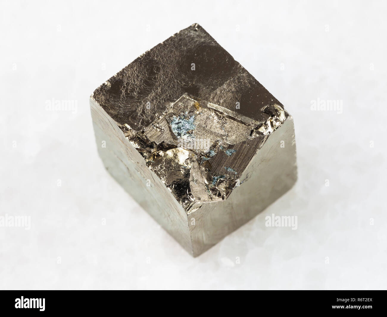 raw pyrite crystal on white marble Stock Photo - Alamy