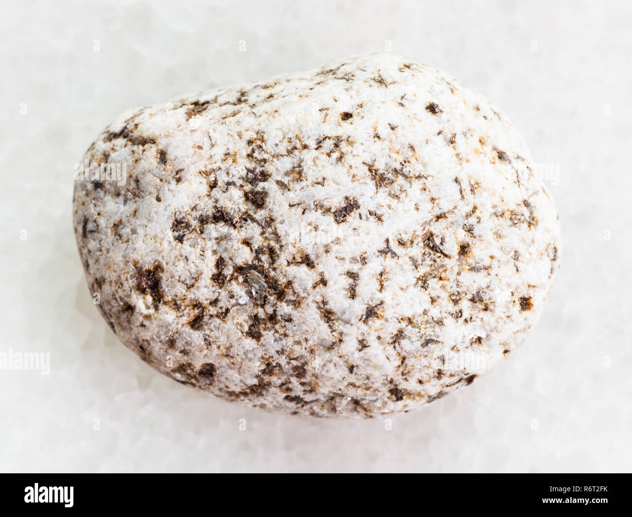 tumbled of white Granite stone on white marble Stock Photo - Alamy