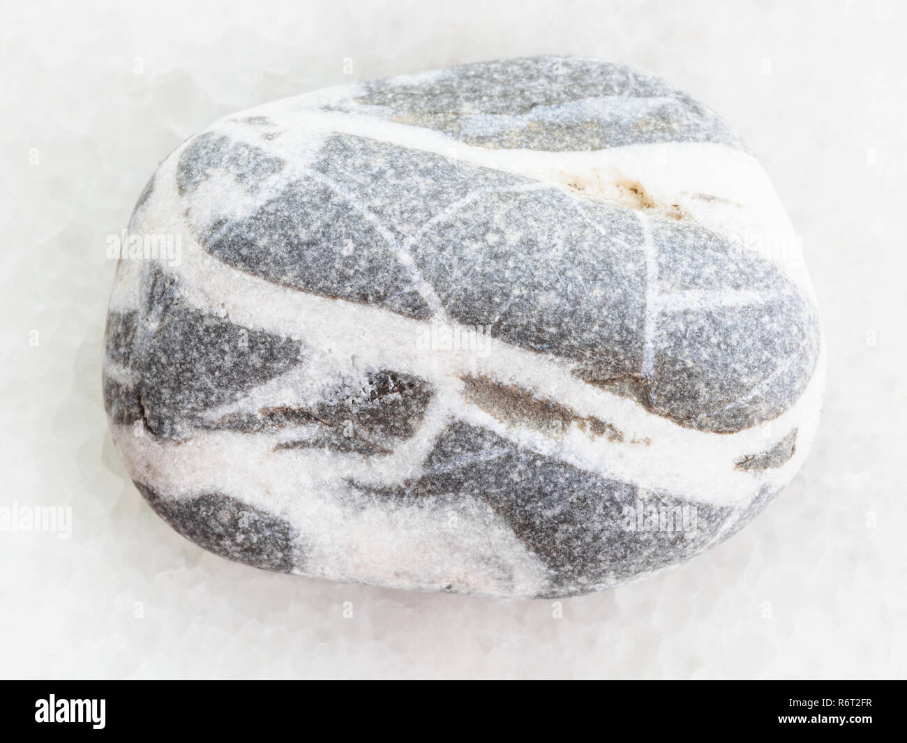 tumbled gray Gneiss stone on white marble Stock Photo - Alamy