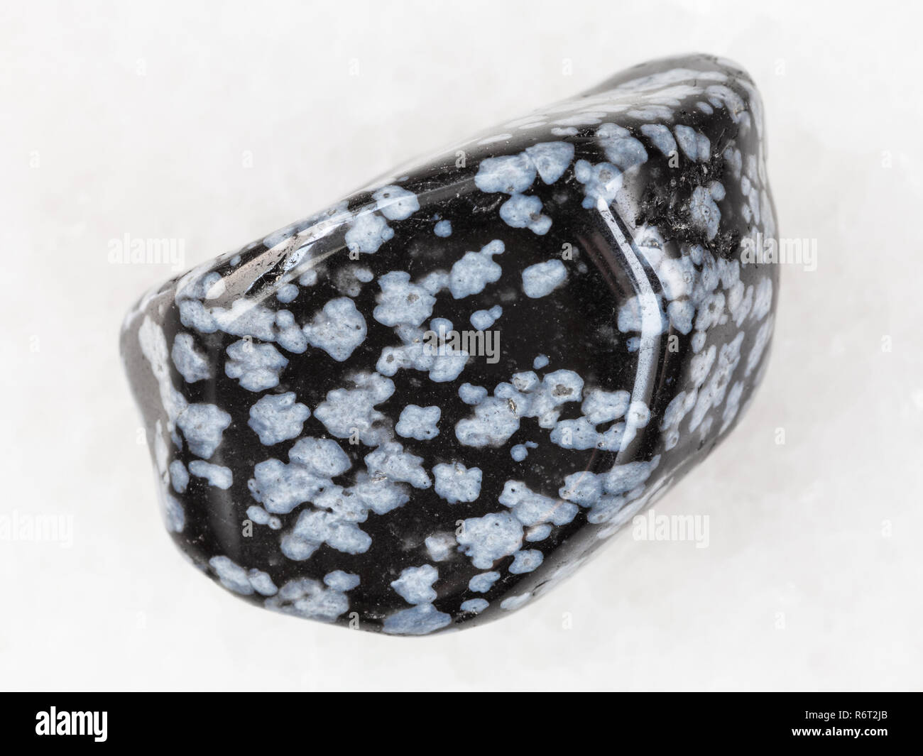 tumbled snowflake obsidian gem stone on white Stock Photo - Alamy