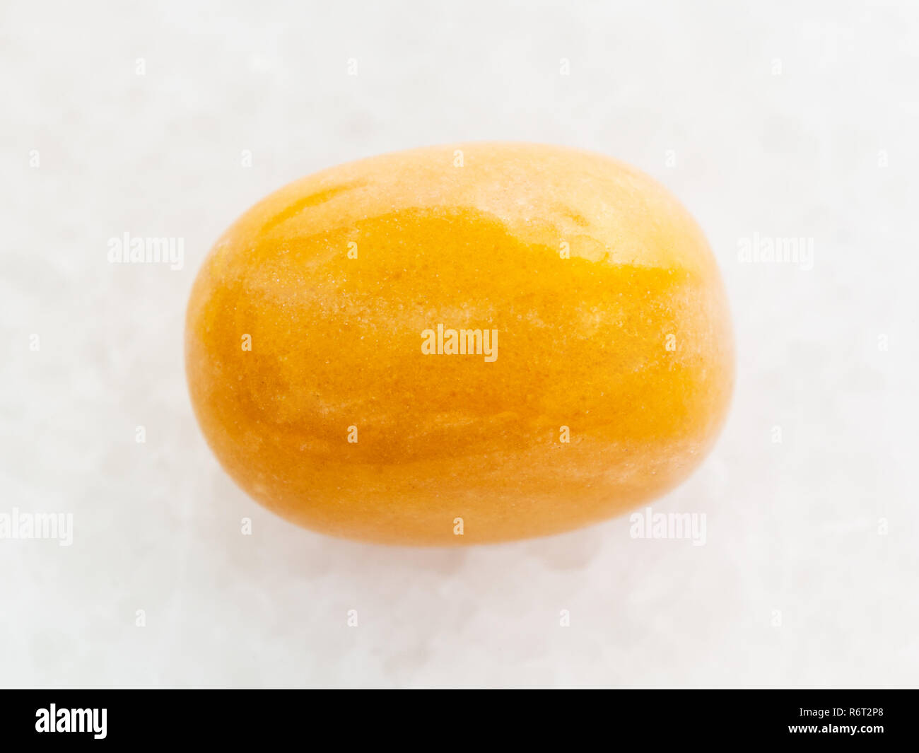 tumbled yellow jasper gemstone on white Stock Photo - Alamy