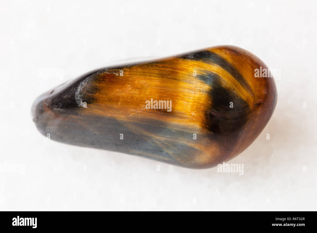 tumbled tiger's eye and hawk's eye gemstone Stock Photo - Alamy