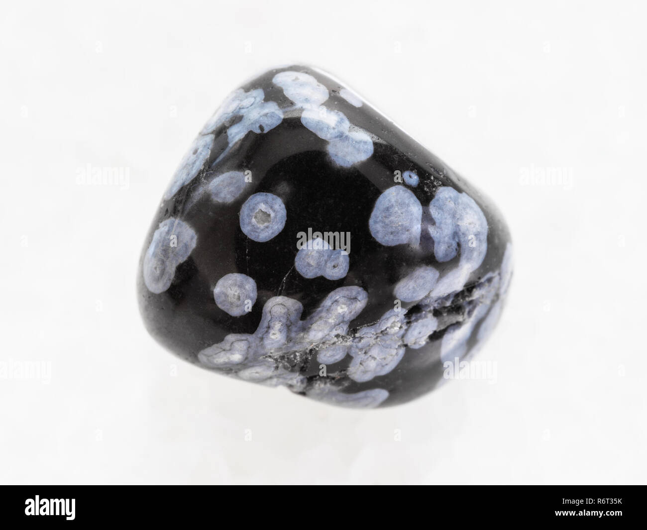 tumbled snowflake obsidian gemstone on white Stock Photo - Alamy