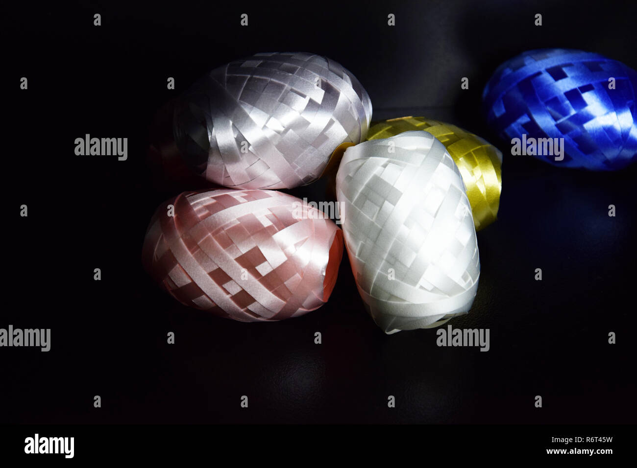 Curling Ribbon - Colorful gift wrapping band on black background Stock ...