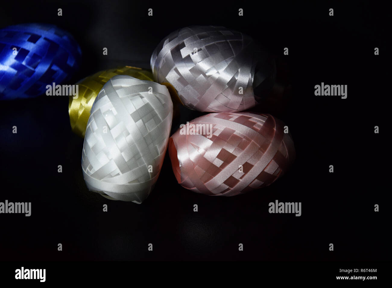 Curling Ribbon - Colorful gift wrapping band on black background Stock ...