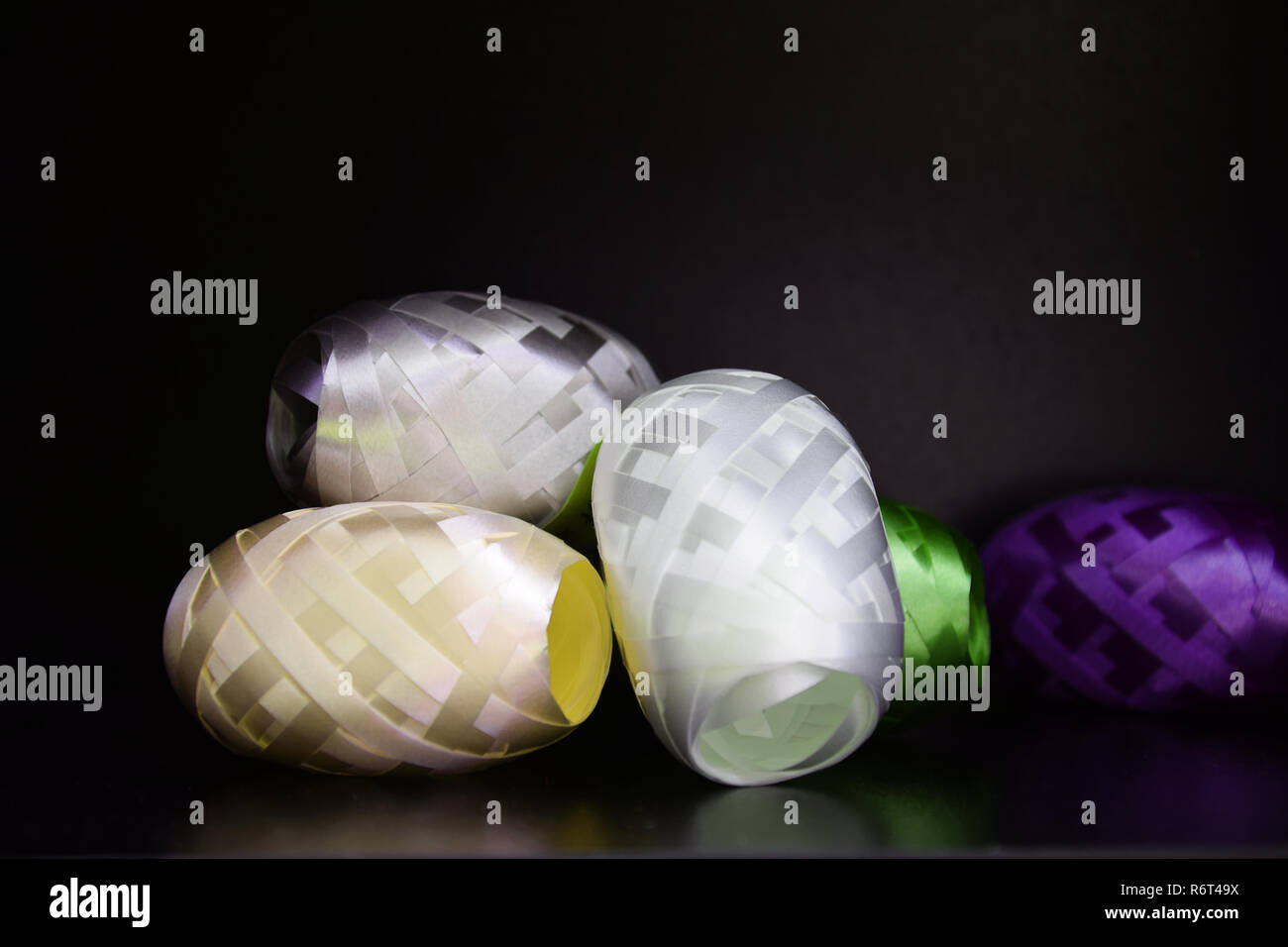 Curling Ribbon - Colorful gift wrapping band on black background Stock ...