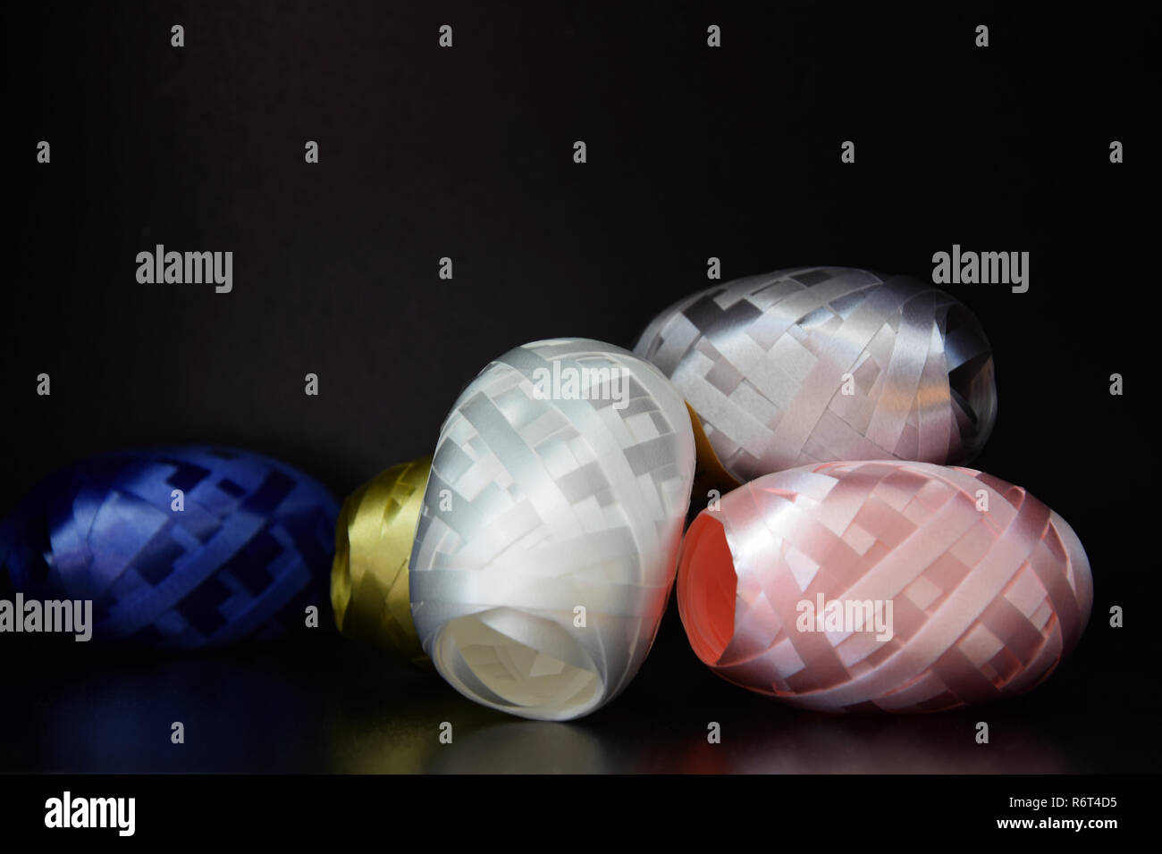 Curling Ribbon - Colorful gift wrapping band on black background Stock ...