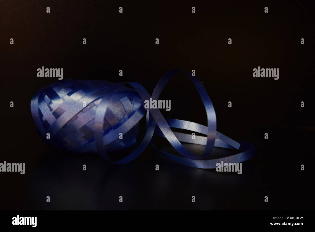 Curling Ribbon - Colorful gift wrapping band on black background Stock ...