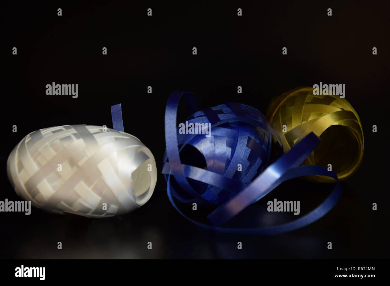 Curling Ribbon - Colorful gift wrapping band on black background Stock ...