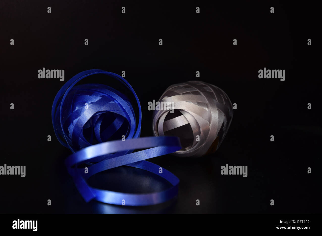 Curling Ribbon - Colorful gift wrapping band on black background Stock ...